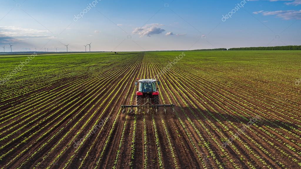 Tractor cultivating field at spring — Stock Photo © valio84sl #111166650