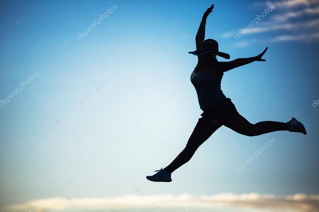 Silhouette of a beautiful girl jumping over sunset — Stock Photo © valio84sl #96831428
