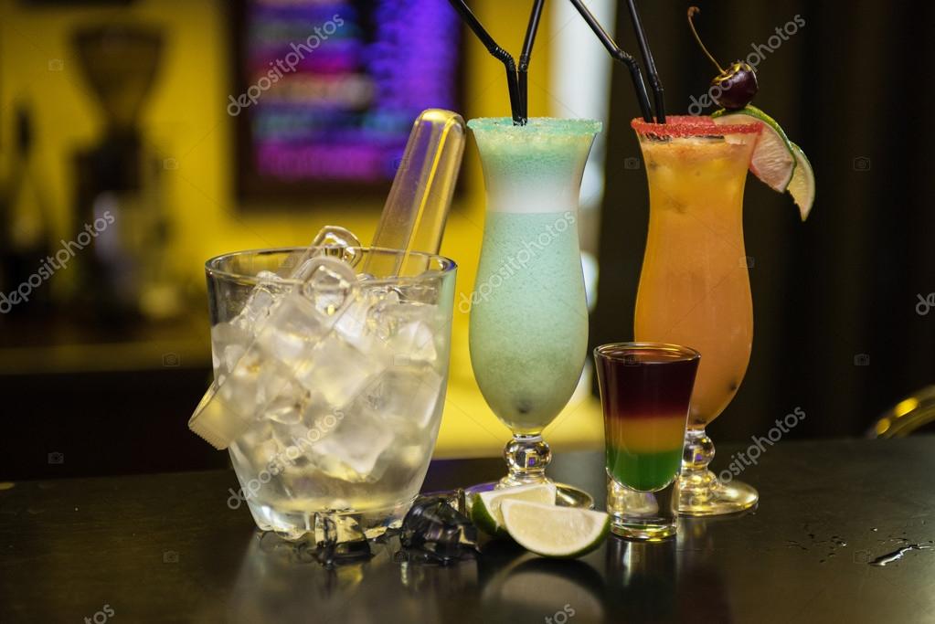 Cocktails on bar background Stock Photo by ©olinchuk 100226544