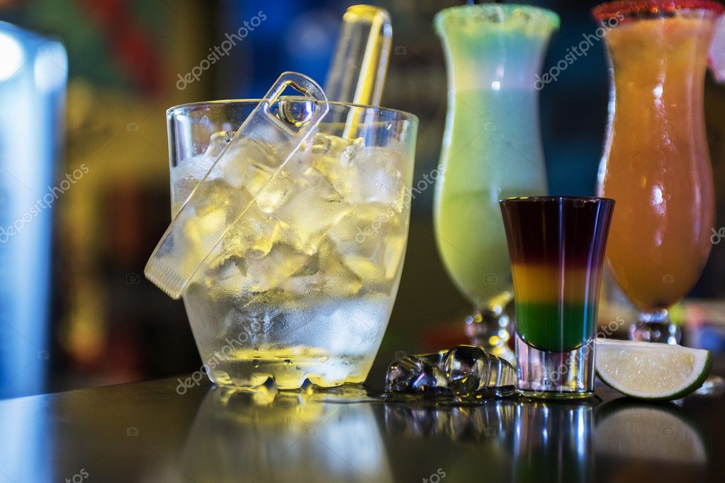 Cocktails on bar background Stock Photo by ©olinchuk 98913896