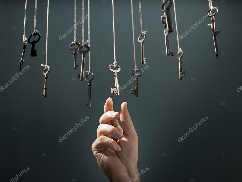 Hand choosing a hanging key — Stock Photo © stocksnapper #59865383