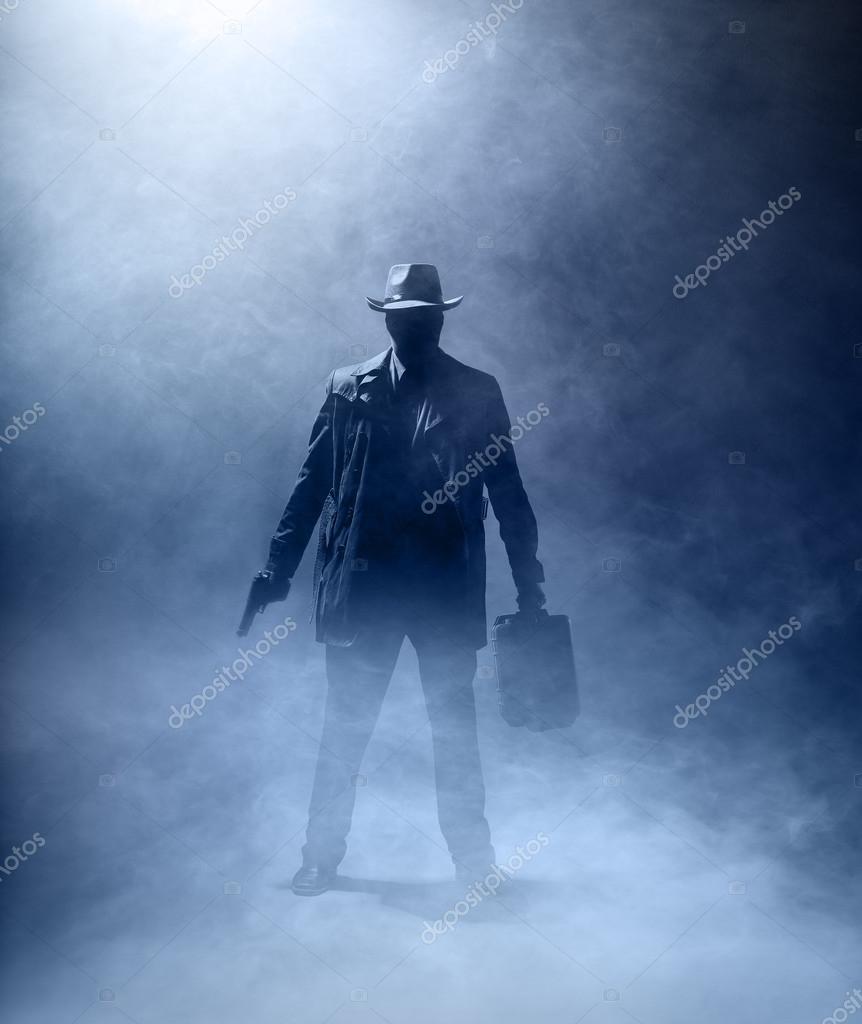 Killer with a gun and a briefcase Stock Photo by ©stocksnapper 66263735