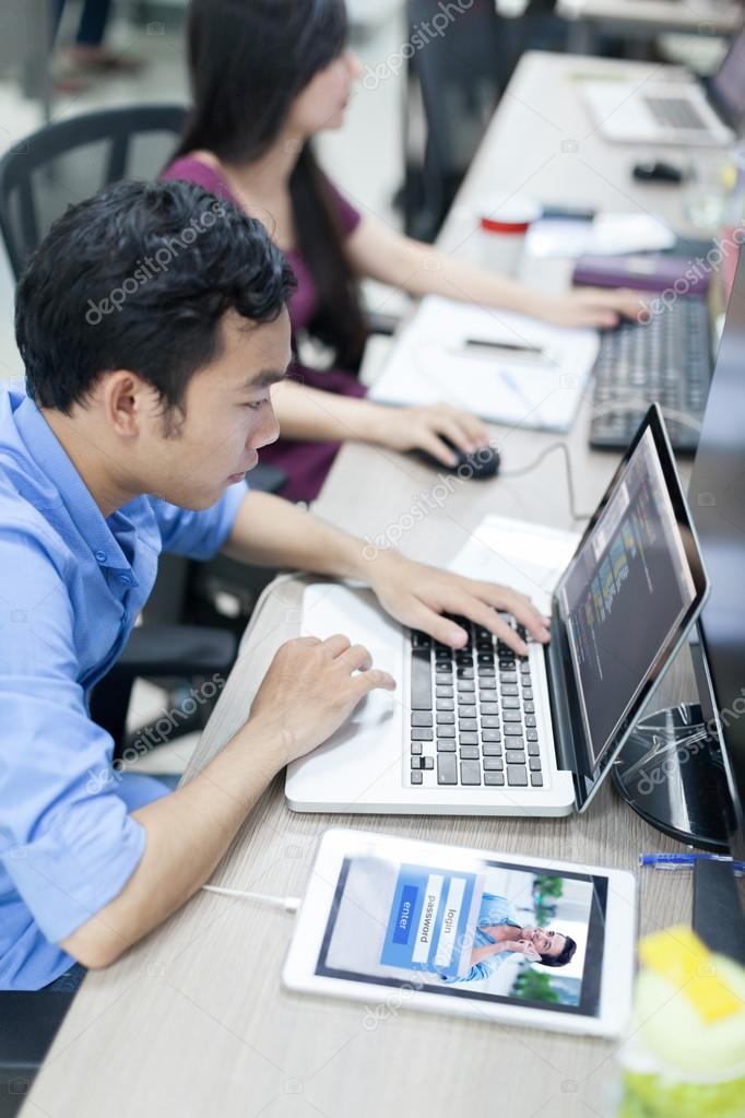 Asian Software Developer Using Laptop Computer — Stock Photo © mast3r ...