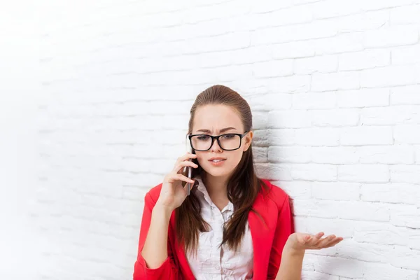 Businesswoman serious negative cell phone call problem wear red jacket ...