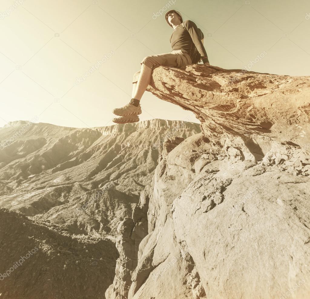 Man sitting on cliff — Stock Photo © kamchatka #67820683