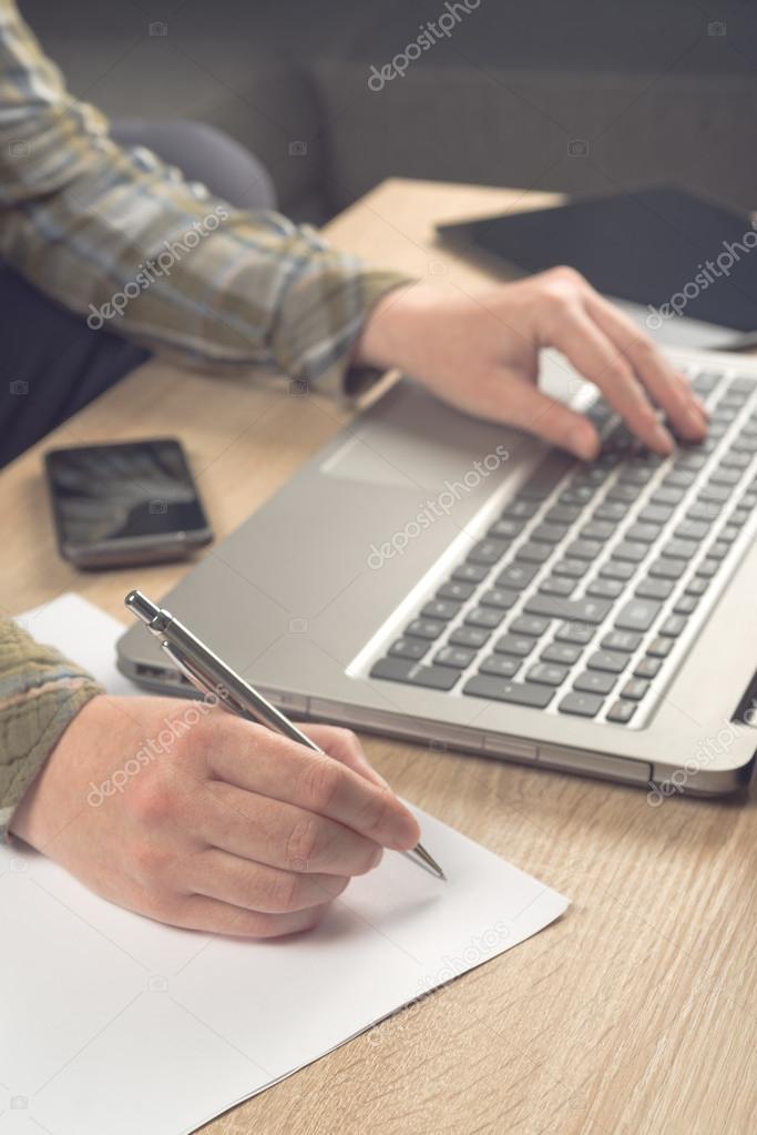 Programmer writing notes on paper — Stock Photo © stevanovicigor #52447819