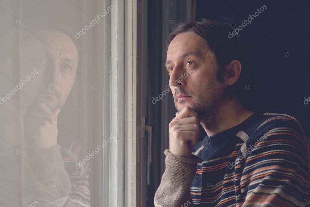 Sad man by the window Stock Photo by ©stevanovicigor 59155199