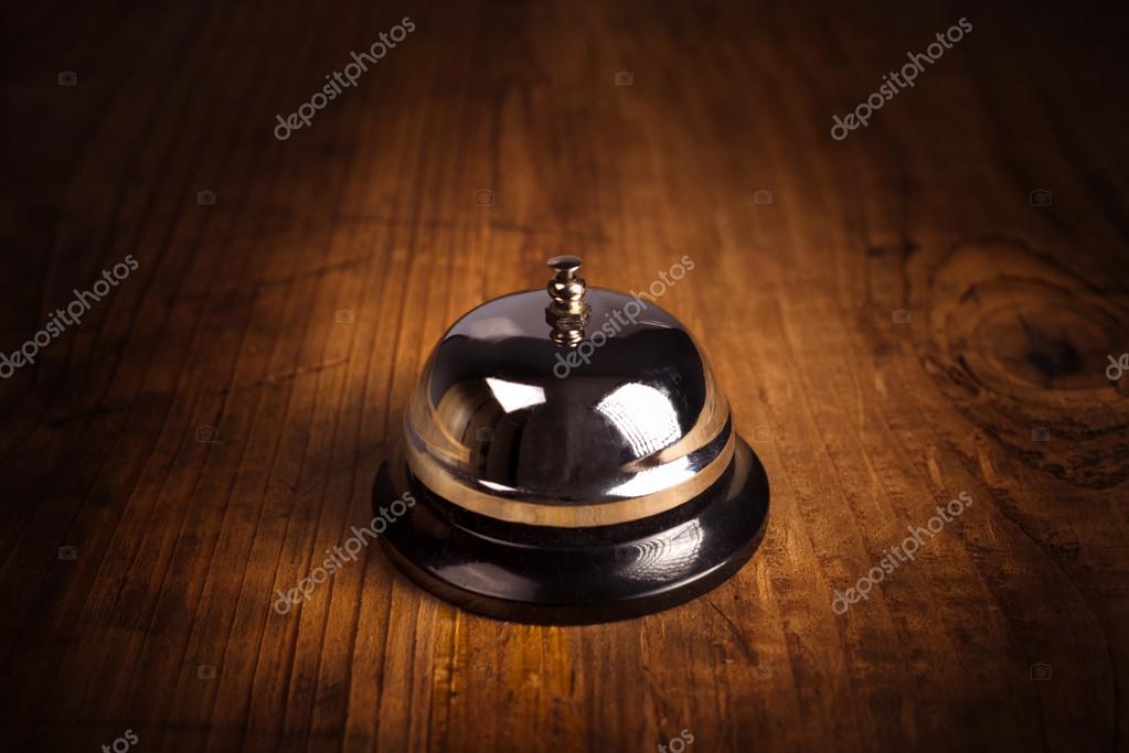 Hotel service call bell on wooden reception front desk — Stock Photo ...