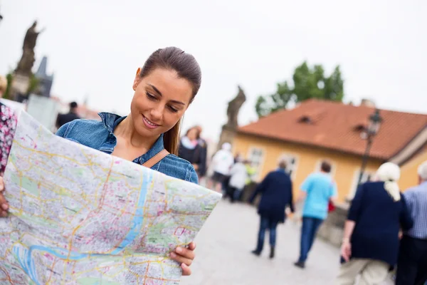 Woman reading a map while on holiday Stock Photo by ©racorn 27774859