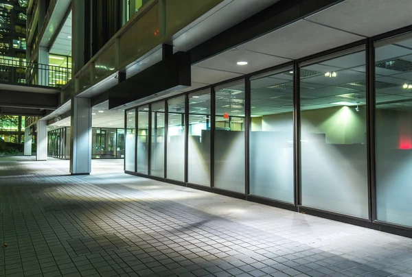 footpath in front of business building at night - Stock Image - Everypixel