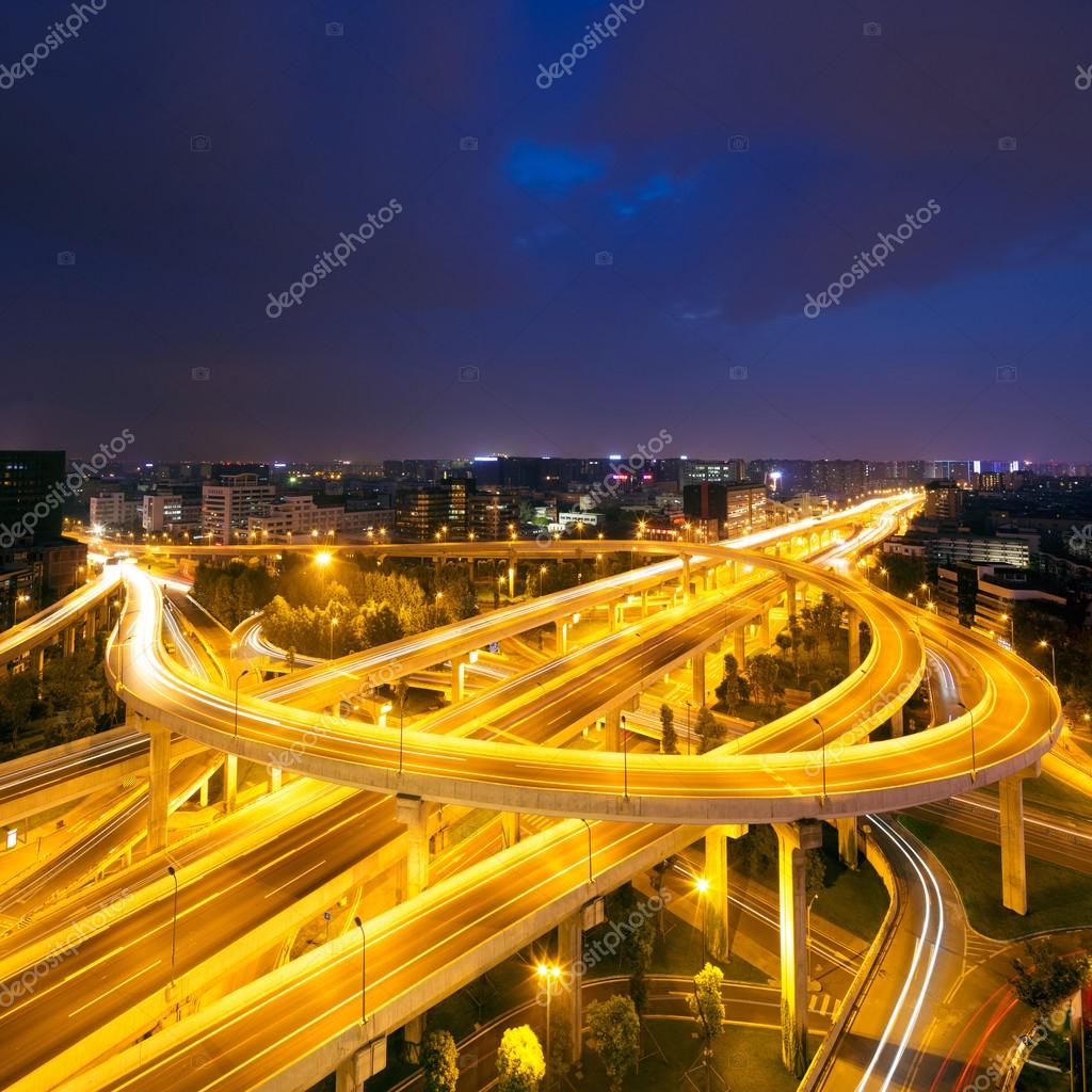Skyline and traffic trails on highway intersection — Stock Photo ...