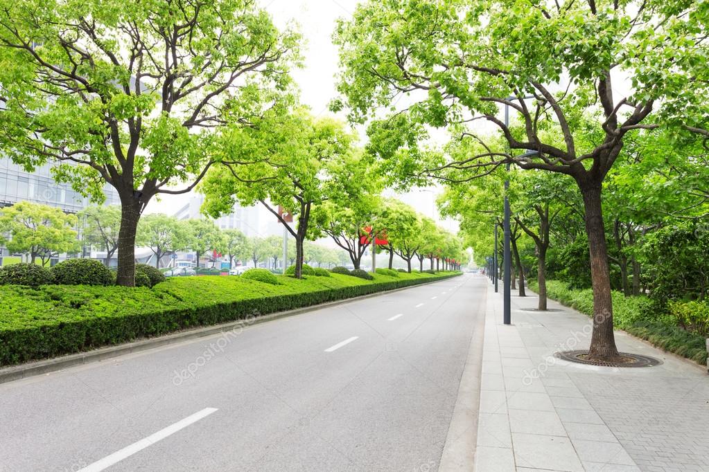 Trees decorated road in modern city — Stock Photo © zhudifeng #67789645
