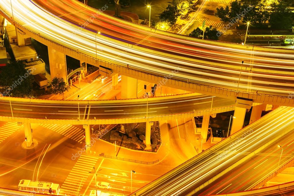 Illuminated road intersection and traffic trails — Stock Photo ...