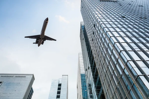 Shanghai: plane over modern buildings — Stock Photo © mamahoohooba #5734506
