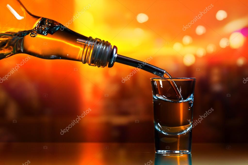Vodka on glass table in bar — Stock Photo © igorr1 #77449436
