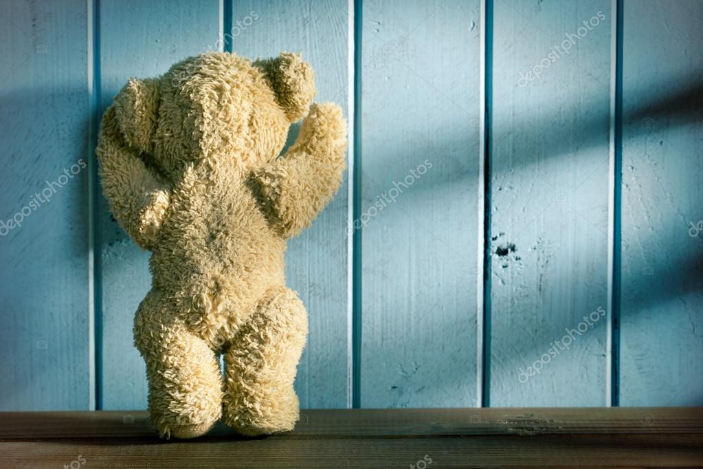 Teddy bear stands in front of a blue wall ⬇ Stock Photo, Image by ...
