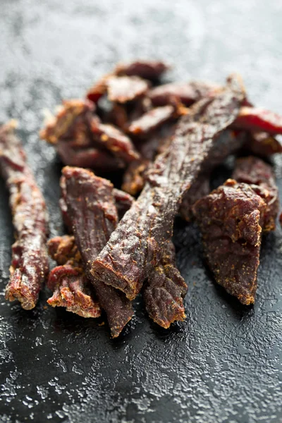 beef jerky on old black table - Stock Image - Everypixel