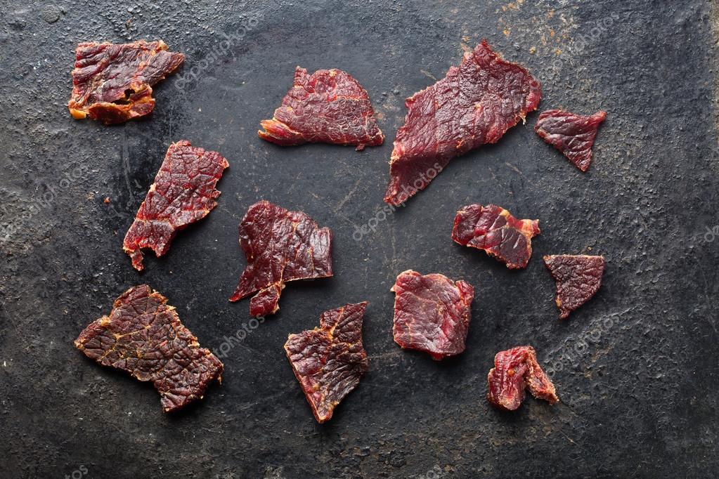 Beef jerky on old black table — Stock Photo © jirkaejc #70701905