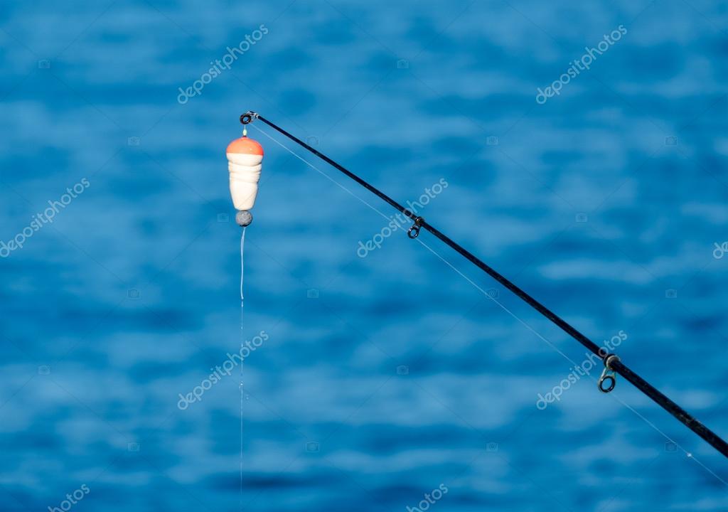 Fishing Bait-Rod with Float against the Blue Sea Water Surface — Stock ...