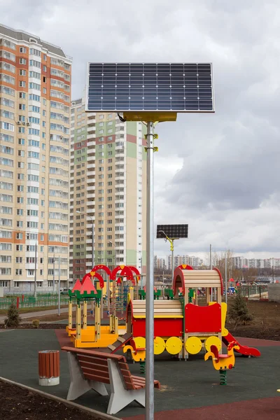 Children's playground in the courtyard of an apartment house with solar ...