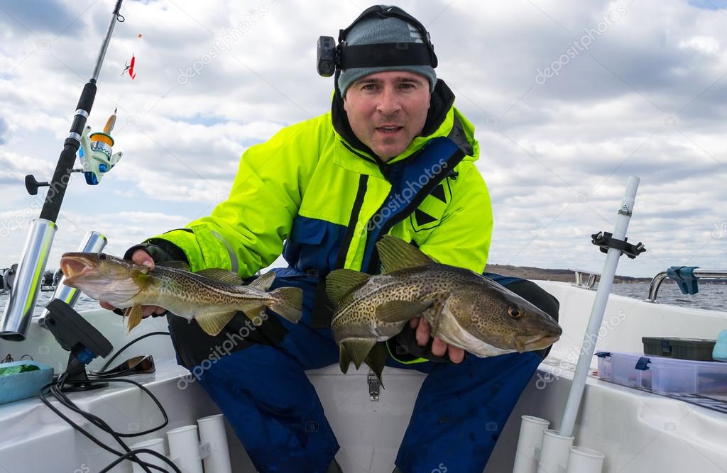 Happy angler with two Baltic cods — Stock Photo © peter77 #70777951