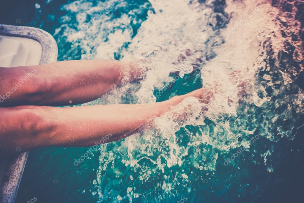Female legs splashing sea water — Stock Photo © dvoevnore #68481141