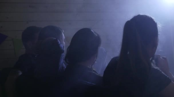 A group of people vaping, inhaling and exhaling large clouds of smoke ...