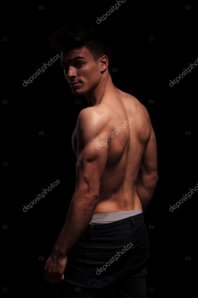 Side portrait on standing muscular man Stock Photo by ©feedough 102642958