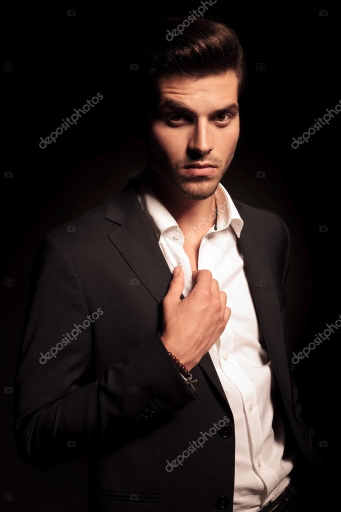 Elegant man holding his collar Stock Photo by ©feedough 52425261