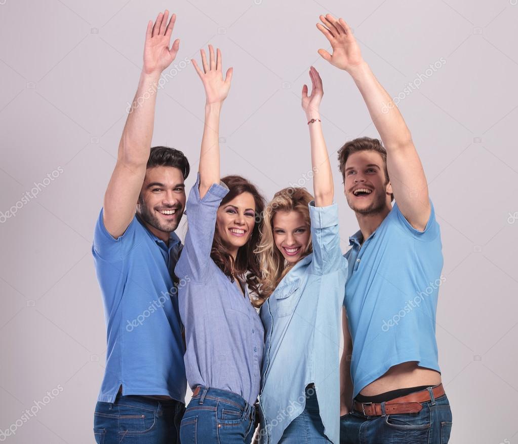 Happy group of young people celebrating success with hands raise Stock ...
