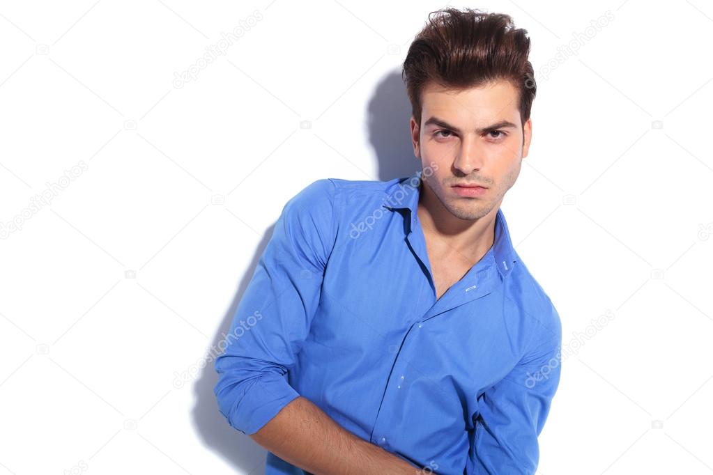 Handsome young man leaning on a white wall — Stock Photo © feedough ...