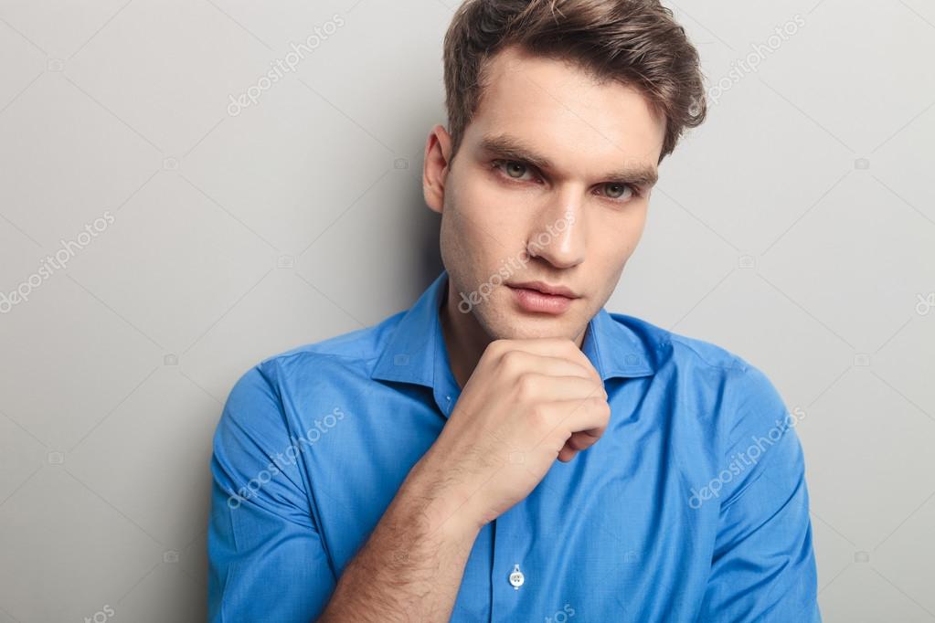 Handsome young man looking at the camera, thinking — Stock Photo ...