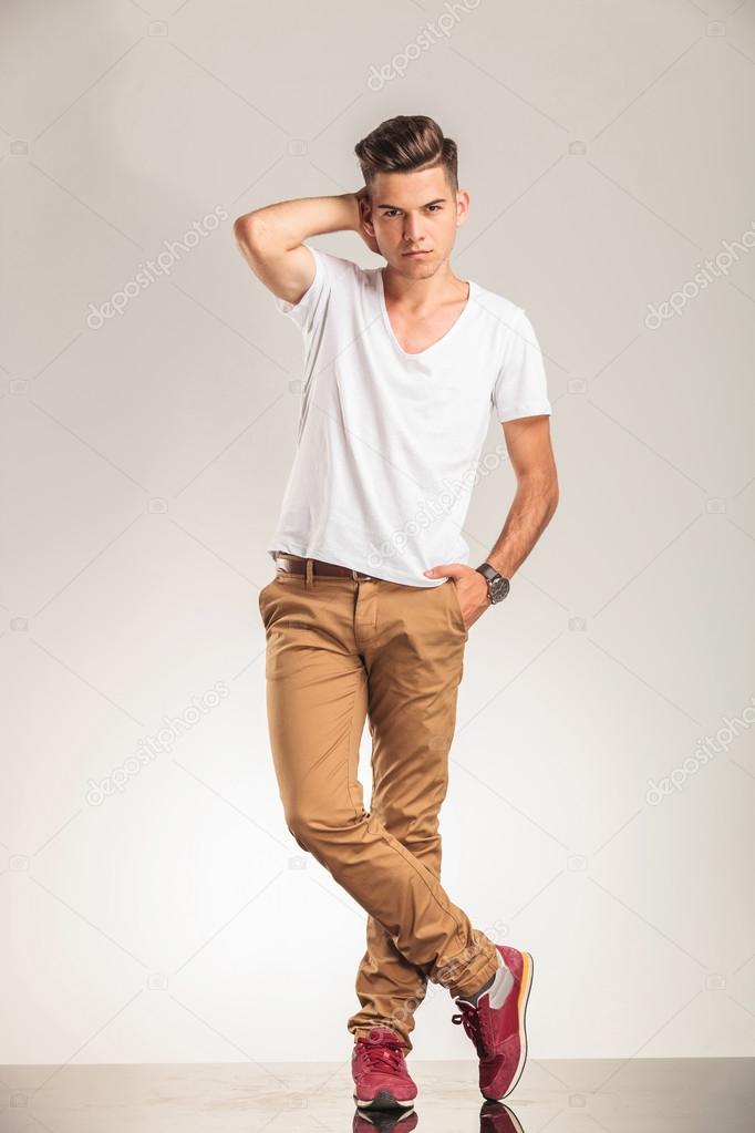 Young man standing with legs crossed Stock Photo by ©feedough 84228692