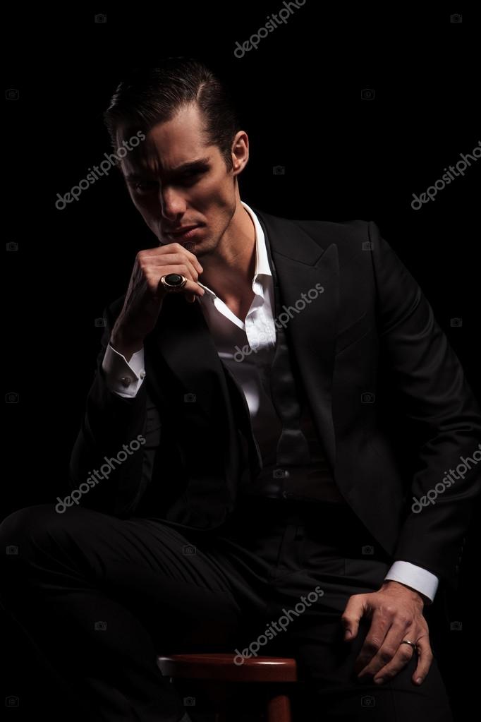 Man in black thinking and looking down Stock Photo by ©feedough 98559246