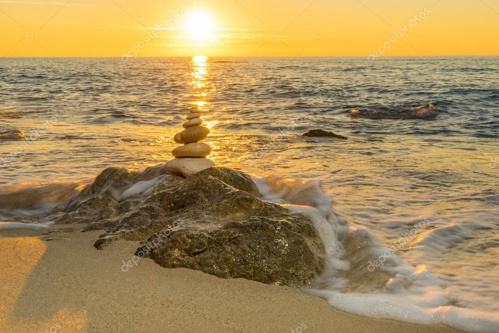 Stones pyramid on sand symbolizing zen, harmony, balance. Ocean Stock ...