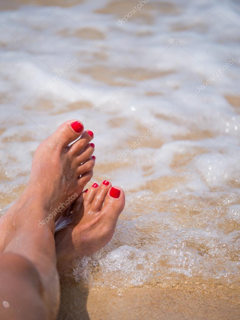 Water splash on female legs on beach — Stock Photo © netfalls #76039363