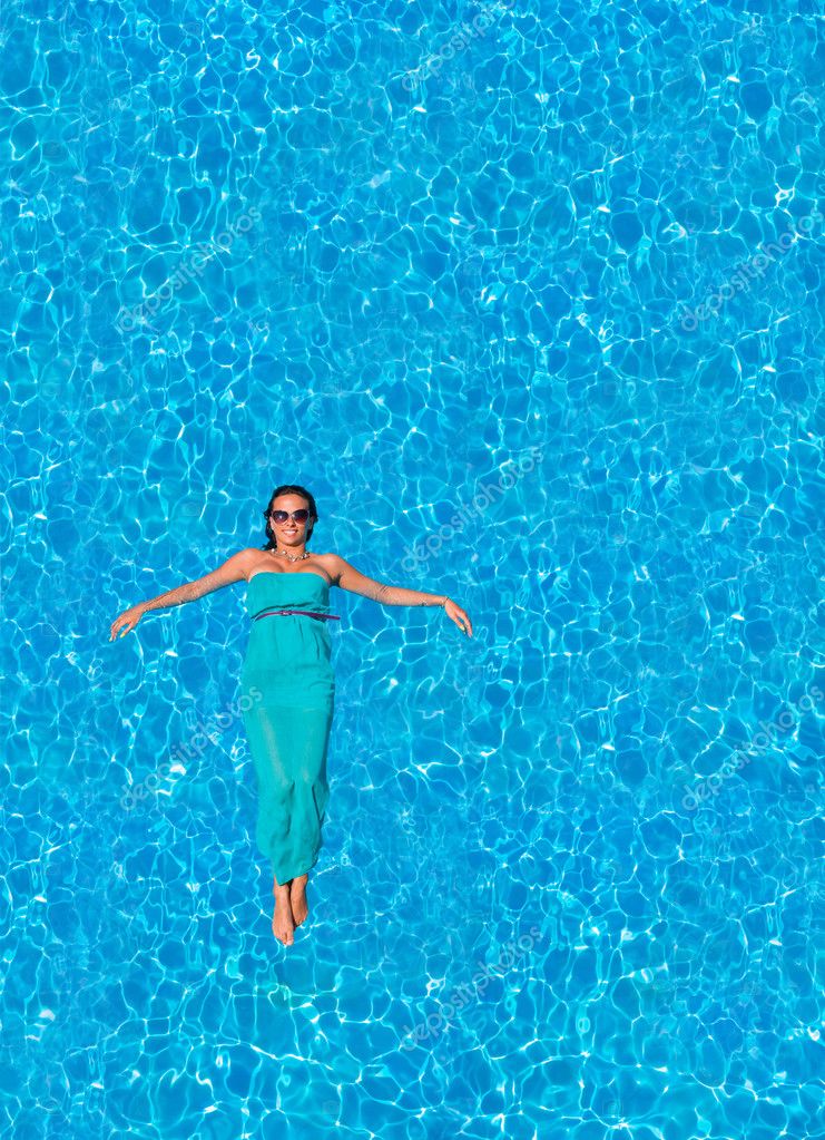 Floating in the swimming pool Stock Photo by ©netfalls 82594842