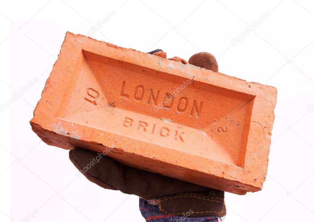 Hand hold red brick against brick wall Stock Photo by ©joruba75 99991896