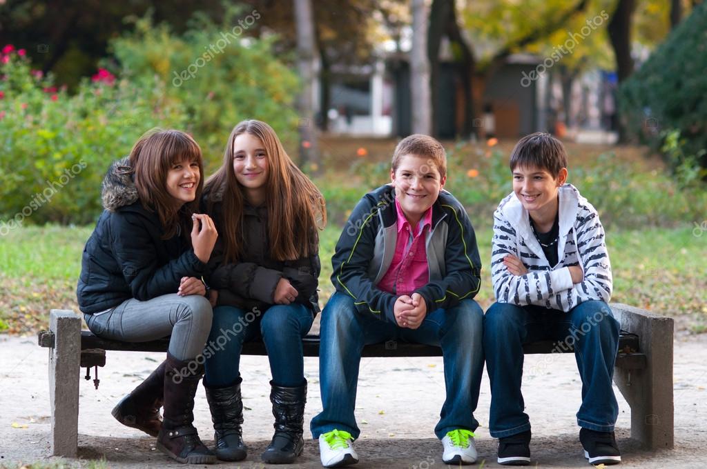 Four teenage friends having fun in the park — Stock Photo © SolidPhotos ...