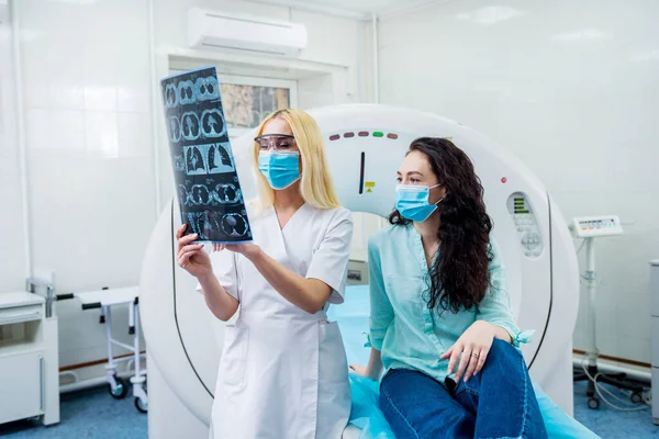 Radiologist with a female patient examining a CT scan — Stock Photo ...