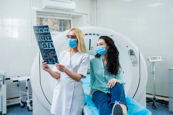 Radiologist with a female patient examining a CT scan — Stock Photo ...