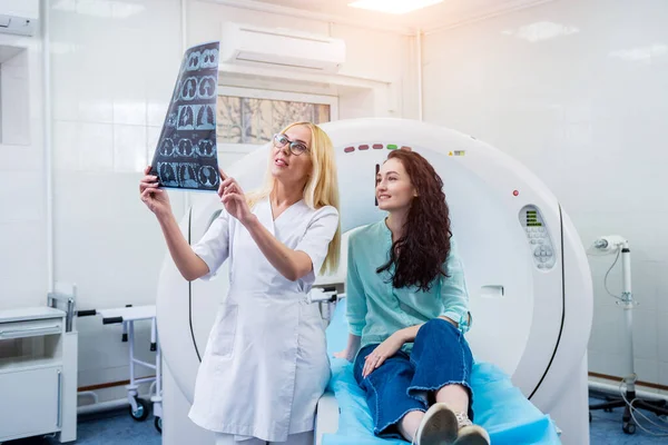 Radiologist with a female patient examining a CT scan — Stock Photo ...