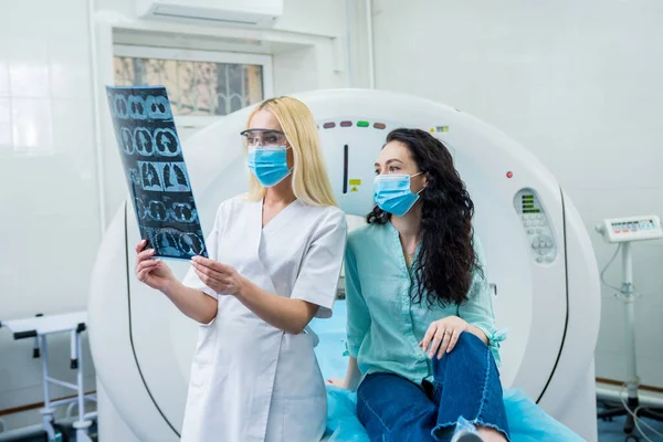 Radiologist with a female patient examining a CT scan — Stock Photo ...