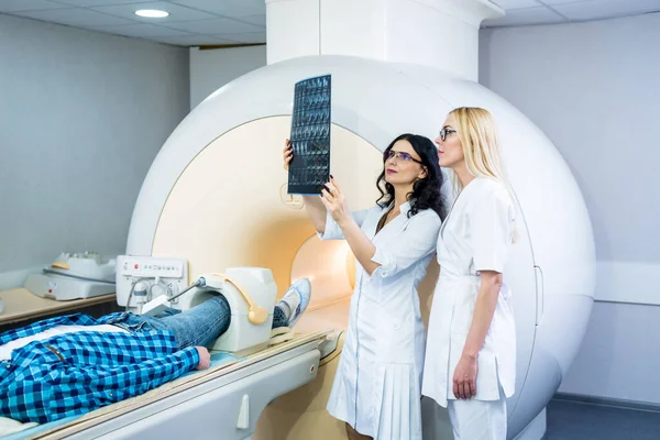 Radiologist with a male patient examining a mri scan — Stock Photo ...