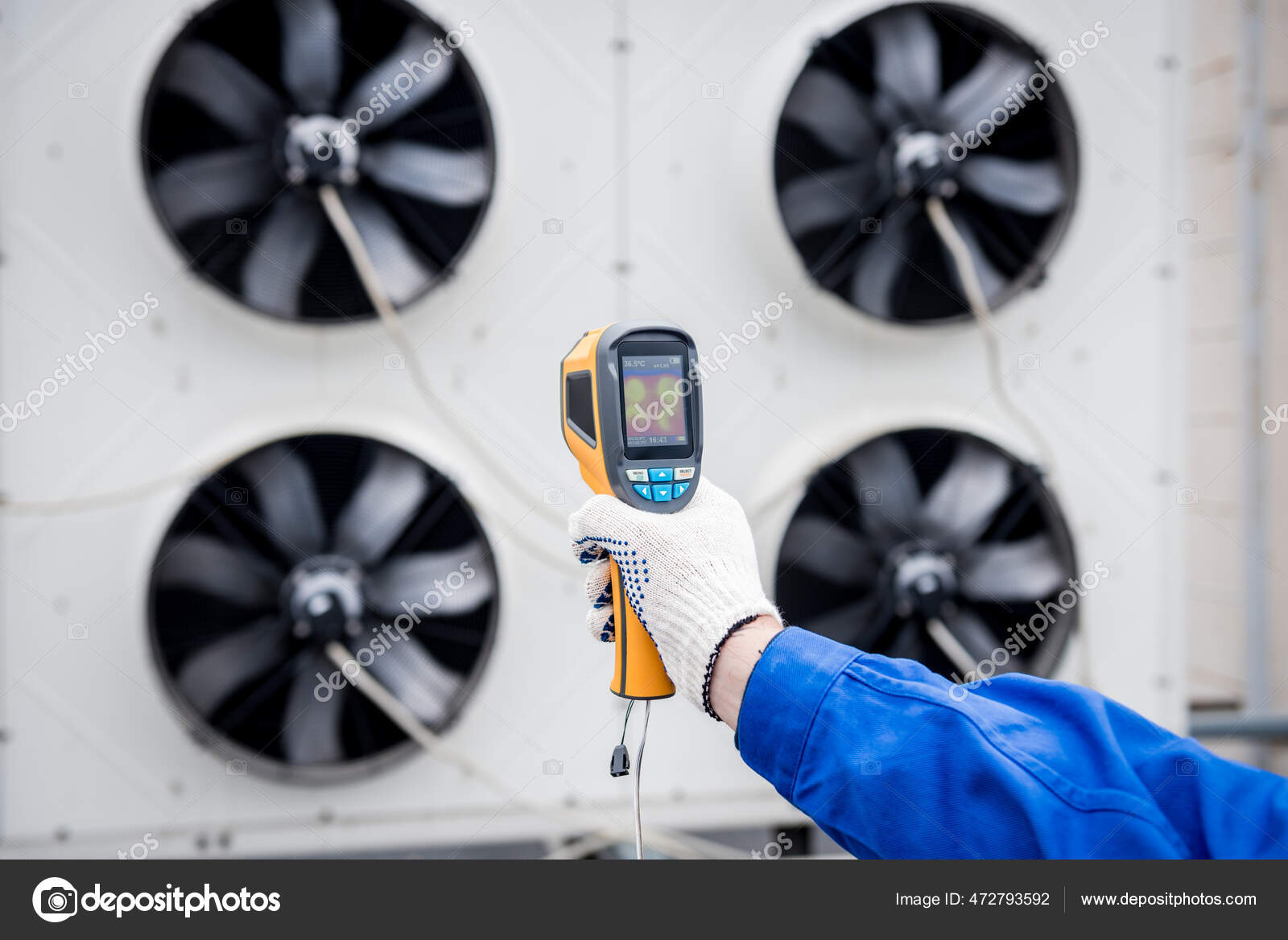Technician uses a thermal imaging infrared thermometer to check the ...