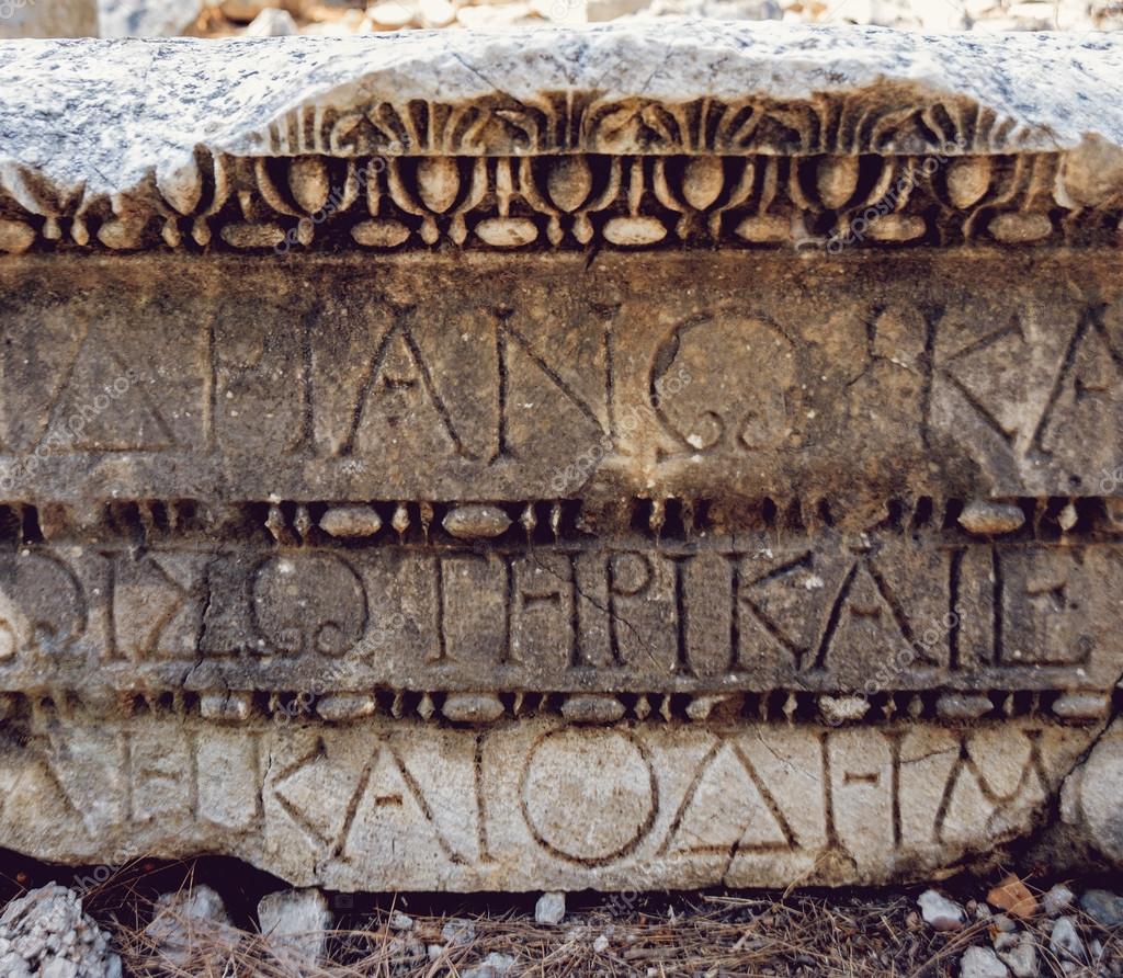 Antique letters carved on stone — Stock Photo © Romaset #97387538