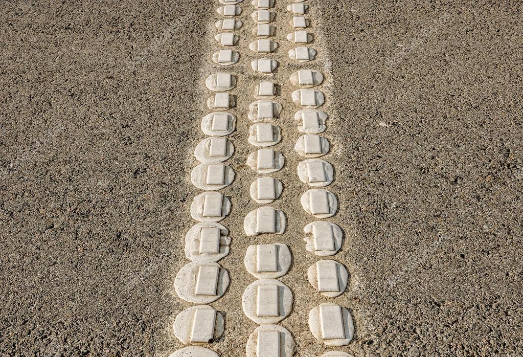 Speed bumps on asphalt road. Stock Photo by ©luckylia 116878652
