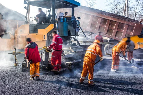 Workers making asphalt with shovels at road constructio — Stock Photo ...