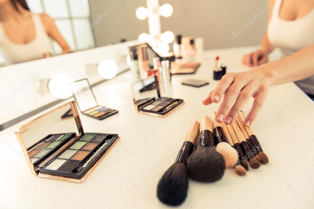 Beautiful girl doing makeup Stock Photo by ©GeorgeRudy 108331594