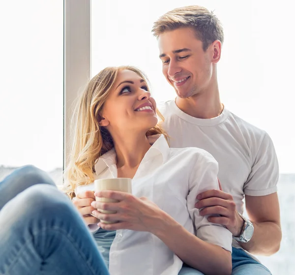 Romantic couple drinking wine at home — Stock Photo © Goodluz #27926209